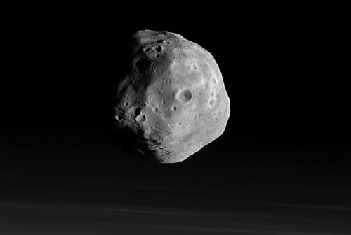 Solving the mystery of the strange 'crater chains' on Martian moon ...